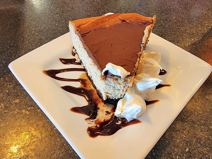 A slice of chocolate cream pie that understands the importance of proper whipped cream-to-filling ratio. Dessert mathematics at its most delicious.