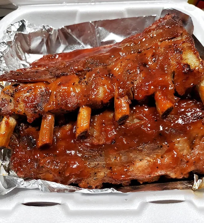 Ribs glistening with sauce that demands to be licked from fingers. No white tablecloths needed for this kind of dining bliss.