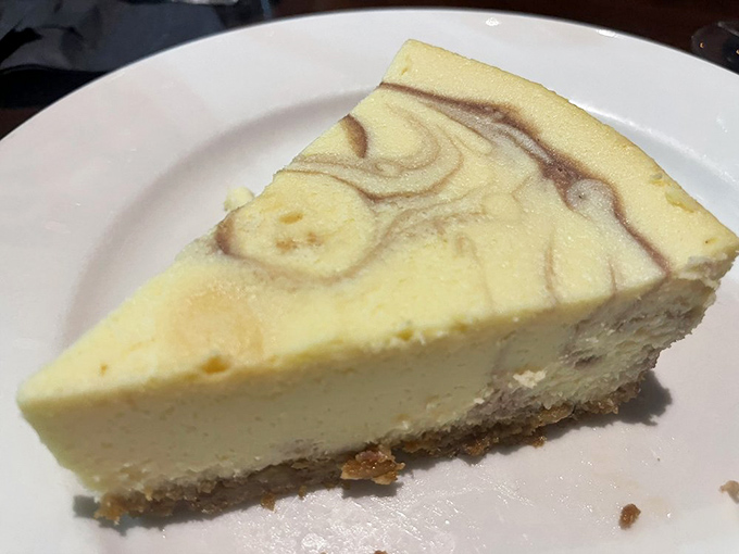 Cheesecake with artistic ambitions. That raspberry swirl isn't just decoration—it's the flavor equivalent of a plot twist in your dessert story.