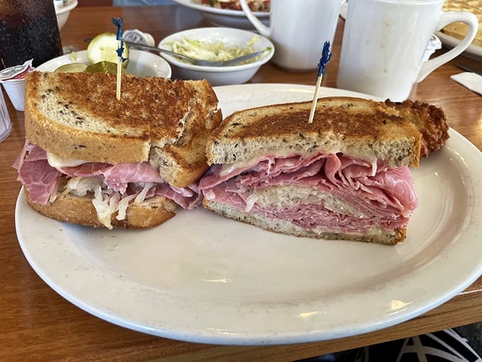 A proper Reuben sandwich—the kind that requires both hands and several napkins. That sauerkraut isn't just tangy—it's transformative.
