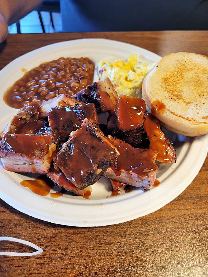 Rib tips bathed in that signature sauce, served with baked beans and cornbread—a plate that makes you understand why napkins were invented.