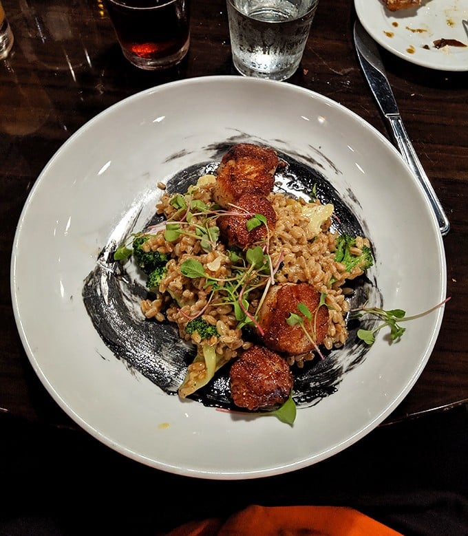 Perfectly seared scallops nestled among grains and microgreens. A dish that manages to be both comforting and sophisticated at once.