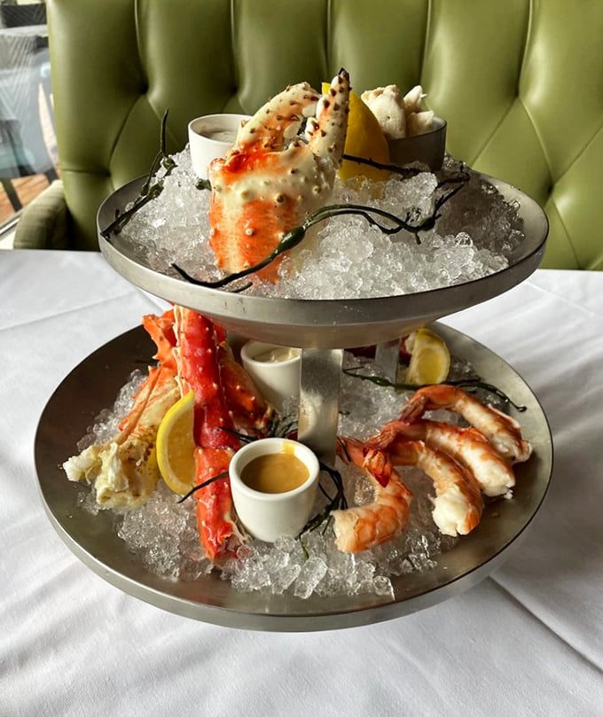 The seafood tower arrives like Neptune's personal offering—a multi-tiered monument to oceanic delights that makes neighboring tables instantly jealous.