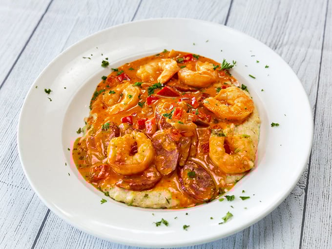 Shrimp and grits—where plump Gulf shrimp swim in a savory sauce atop creamy stone-ground grits—the South's gift to comfort food enthusiasts everywhere.