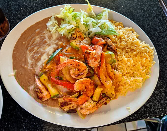 Sizzling shrimp fajitas with colorful peppers and onions—a plate that announces its arrival with both aroma and sound.