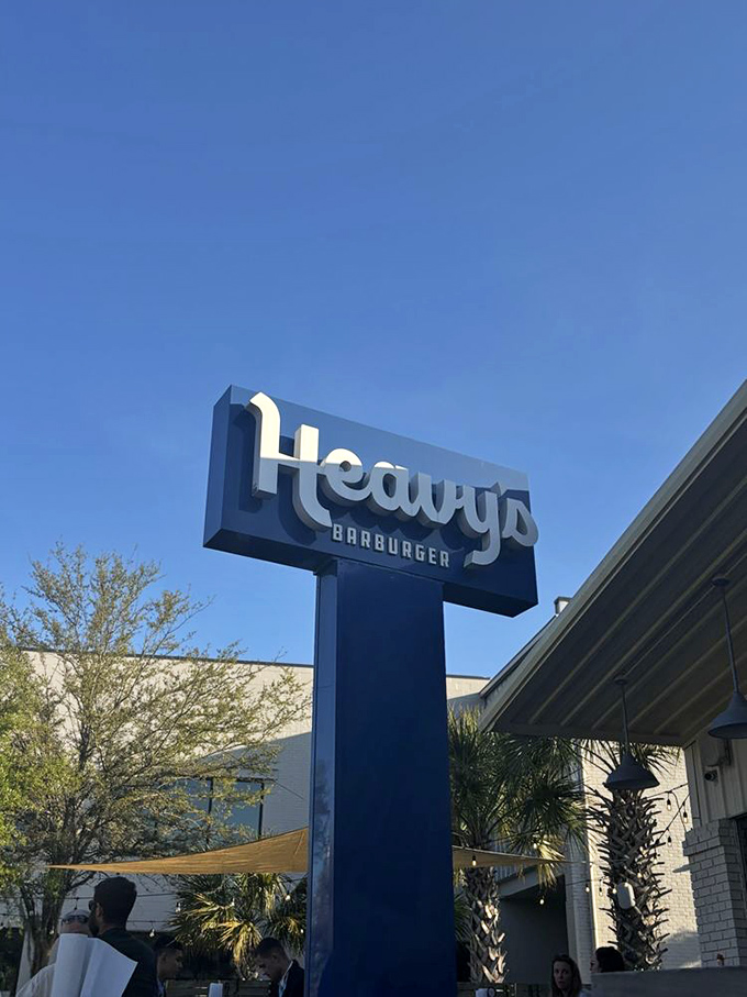 The sign that's guided countless hungry pilgrims to burger salvation. Blue against Carolina sky—a beacon of hope for empty stomachs.