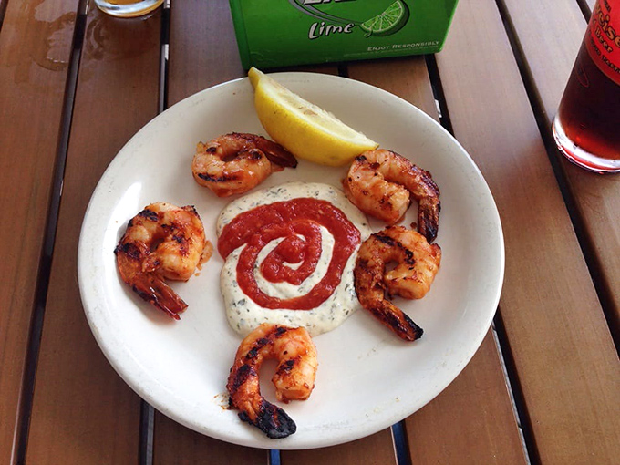 Grilled shrimp arranged like a clock around a creamy sauce spiral—proof that simple ingredients with proper technique create food that's both art and satisfaction.