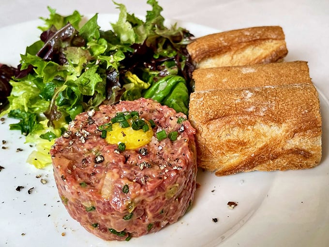 Steak tartare with a golden egg yolk crown—raw perfection for the culinary brave. Trust me, this is worth the leap of faith.