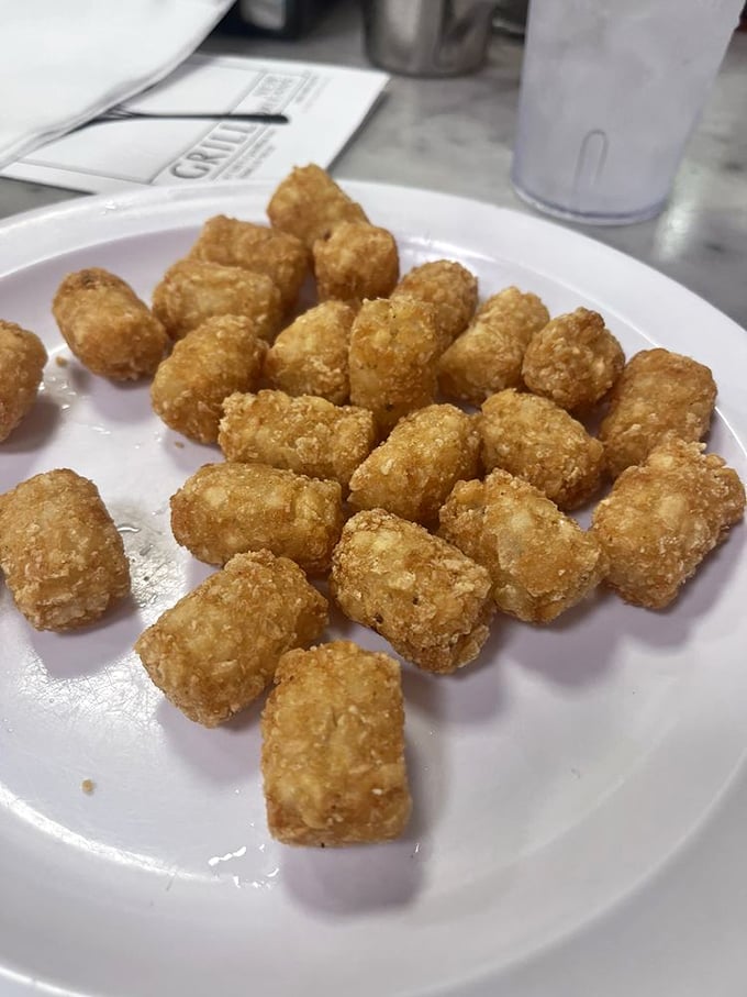 Tater tots that crunch like childhood memories—golden nuggets of potato perfection that make you wonder why you ever grew up.