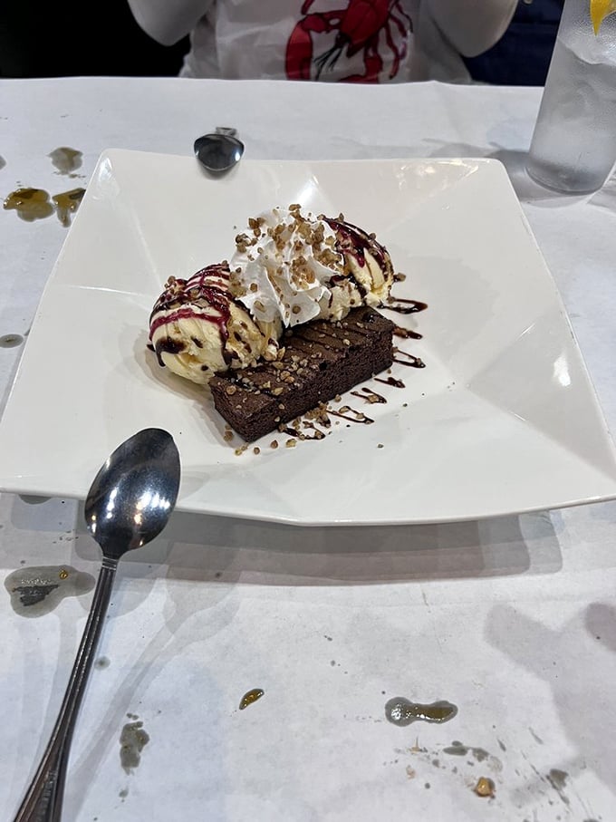 A brownie topped with ice cream—because after conquering mountains of seafood, you deserve a sweet victory lap.