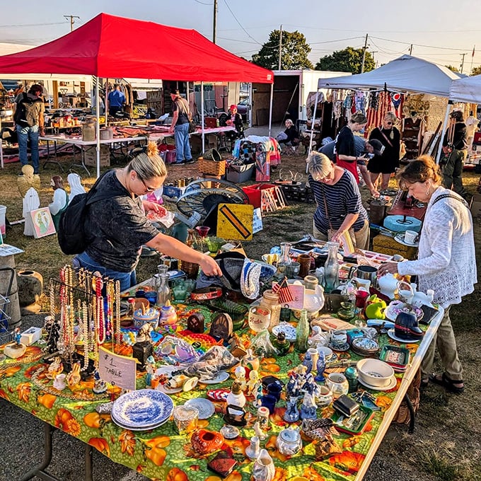 Dawn breaks over a table of possibilities—where early birds and serious collectors converge in the golden hour of antiquing.