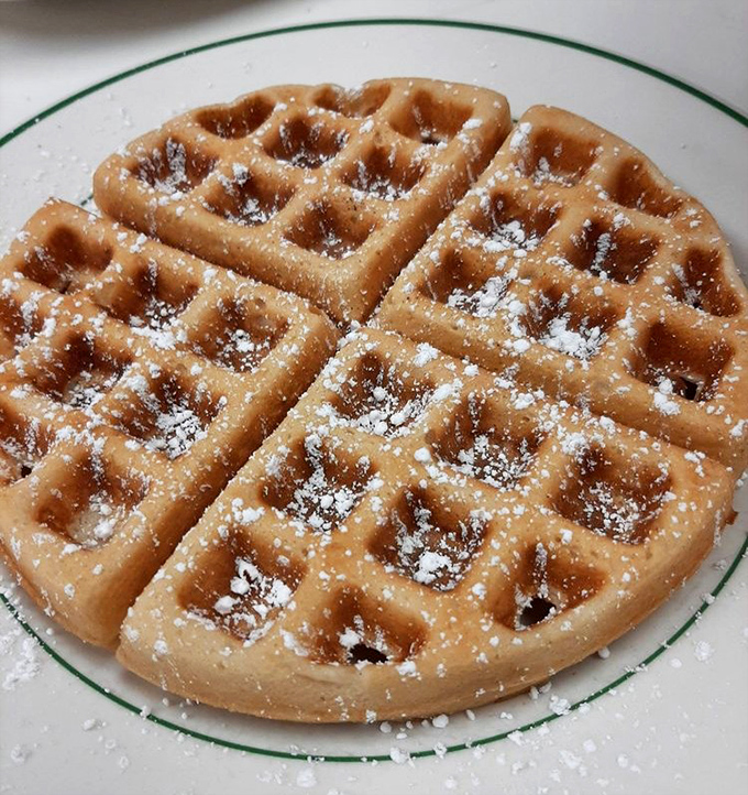 The humble waffle—transformed from batter to beautiful with nothing more than heat, time, and a dusting of powdered sugar.