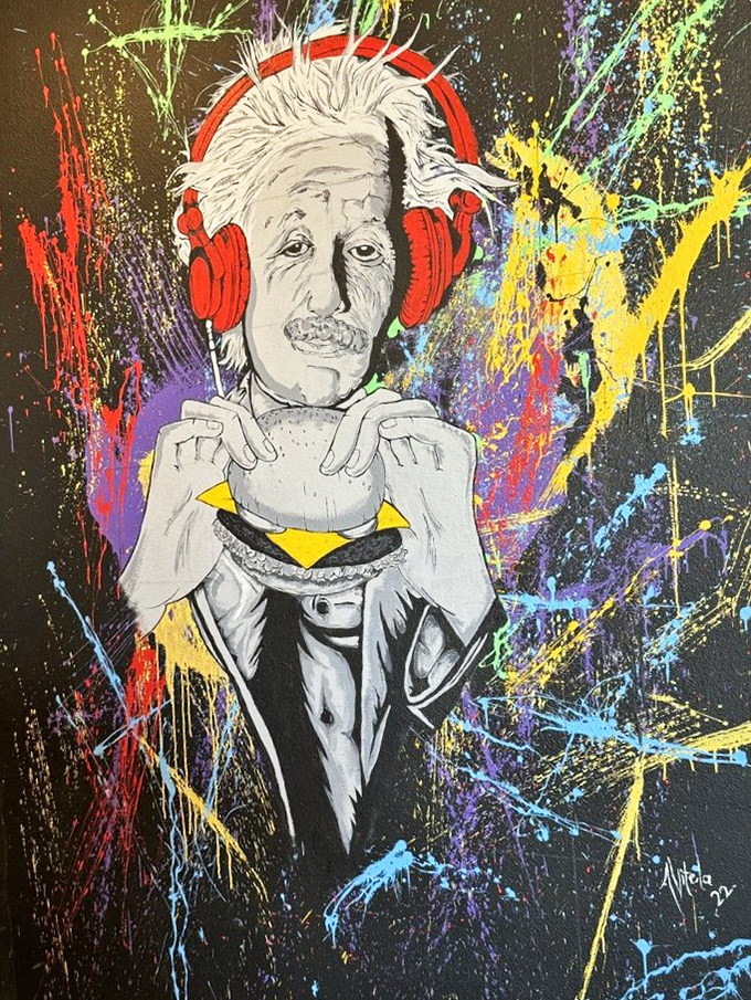 Einstein enjoying a burger with headphones on—because even geniuses know that sometimes the simplest pleasures require your full attention.