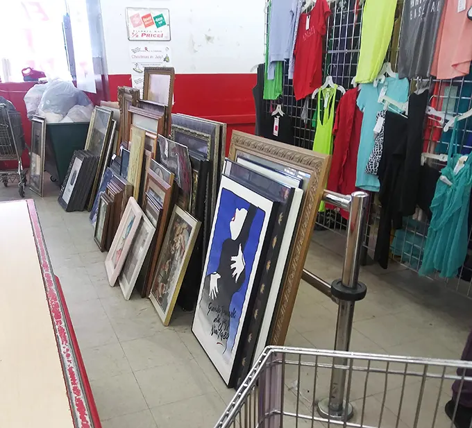 Framed art leaning casually against the wall, waiting for new homes. Someone's discarded decor becomes your conversation piece—all for pocket change.