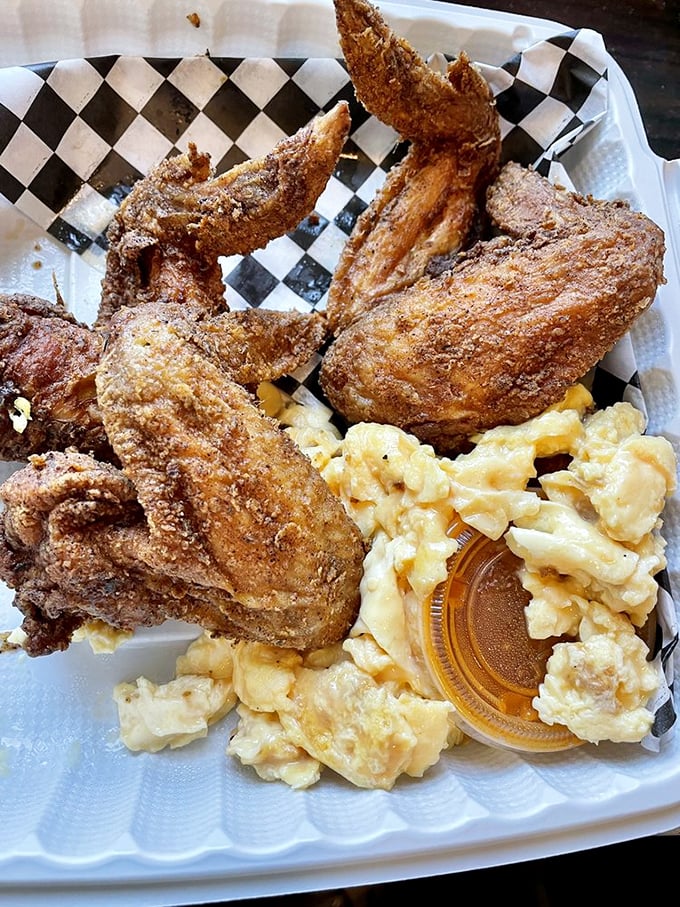 Fried chicken wings and scrambled eggs—proof that breakfast and dinner can coexist beautifully. This checkered paper plate holds the key to happiness.
