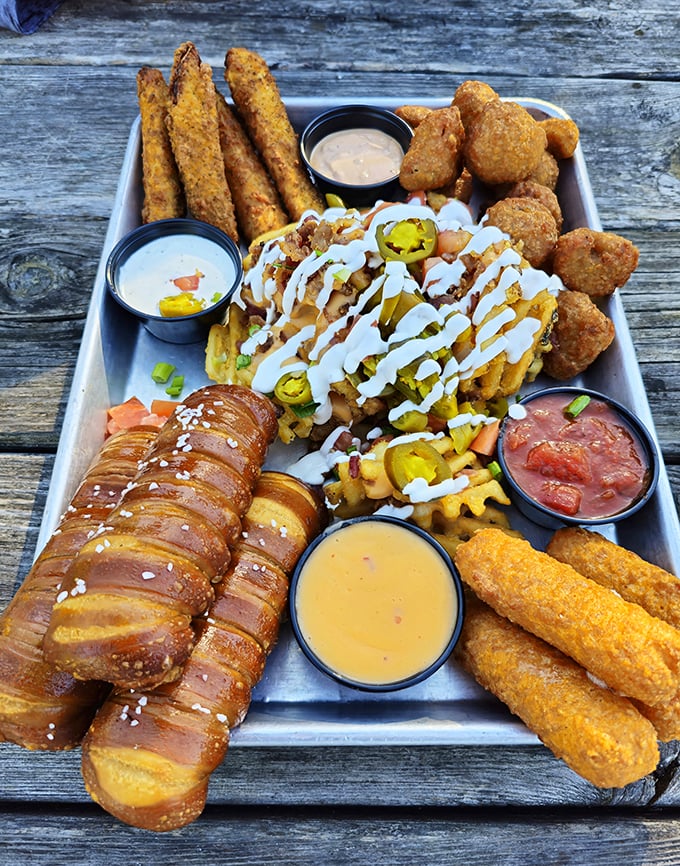 This shareable platter isn't just food—it's a choose-your-own-adventure of fried delights, pretzel dogs, and dipping sauces for every mood.