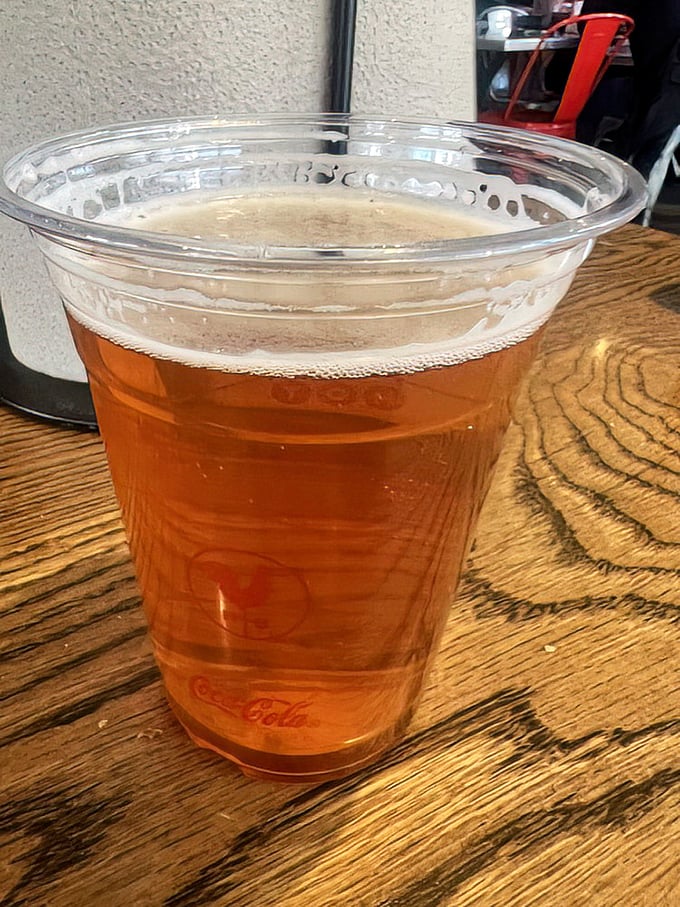 The perfect companion to tame the flames—a cold beer stands ready for rescue operations after "Damn Hot" chicken encounters.