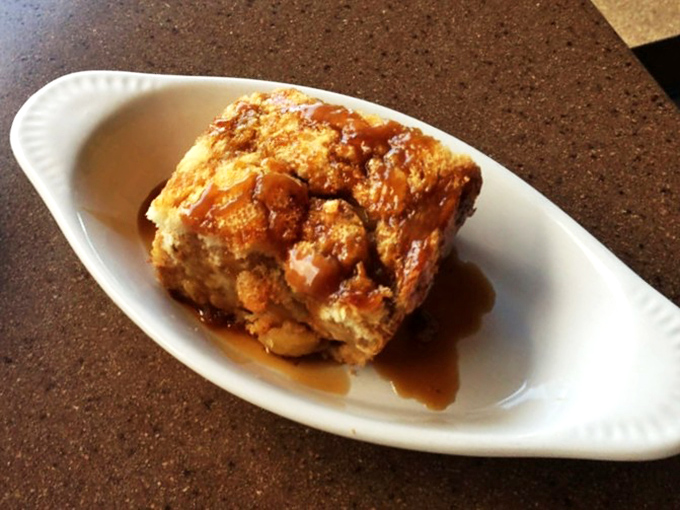 Bread pudding that looks like it would make angels weep—caramelized edges giving way to a tender center bathed in caramel sauce.