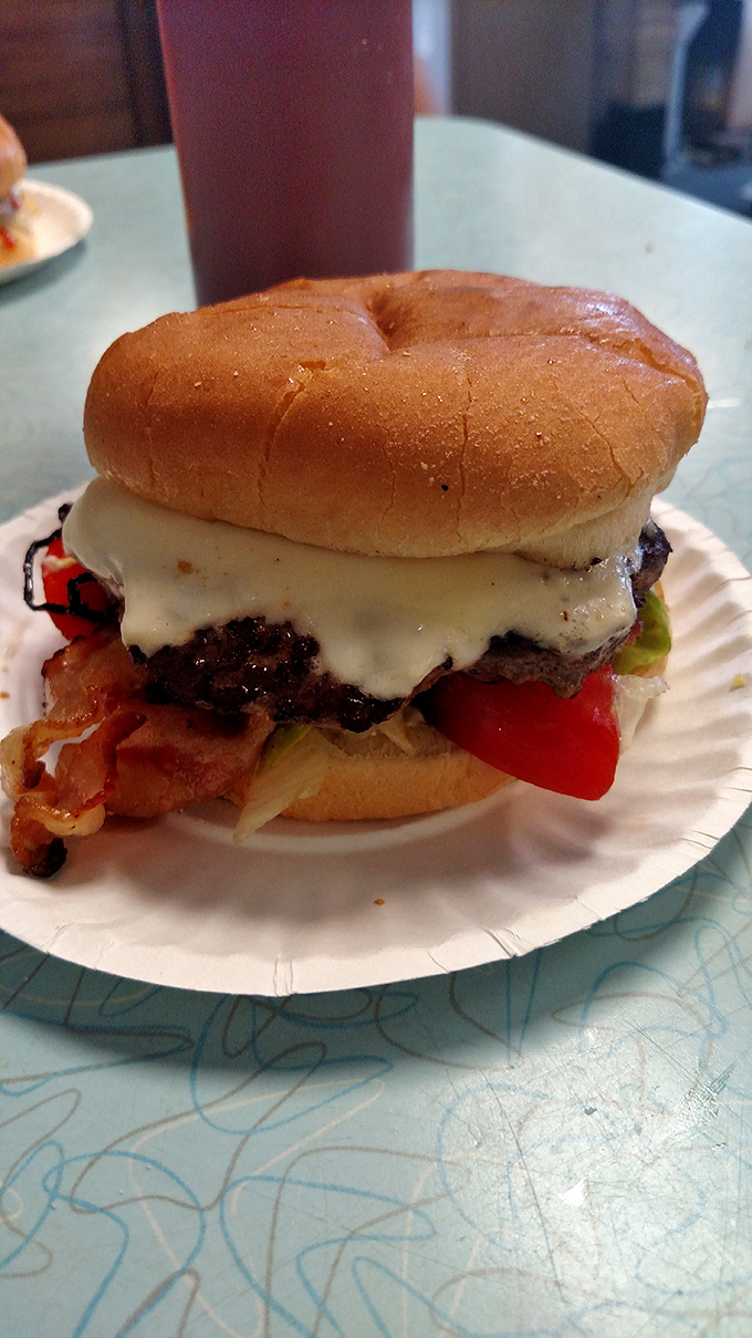 A perfect burger isn't about trendy toppings or artisanal nonsense—it's about beef, cheese, and basic vegetables coming together in perfect, unpretentious harmony.