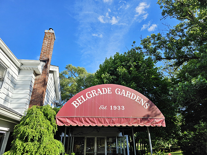 That signature burgundy awning against blue Ohio skies—a beacon of fried chicken excellence that's been calling to hungry travelers since 1933.