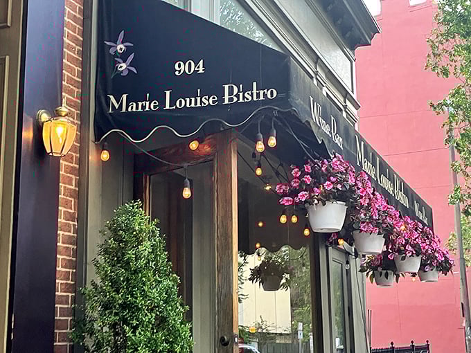 The bistro's elegant facade whispers rather than shouts, adorned with flowers that seem to say, "Yes, something wonderful is happening inside."