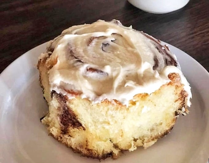 The cinnamon roll that ate Manhattan—swirled perfection topped with frosting that melts just enough to make you forget about your diet.