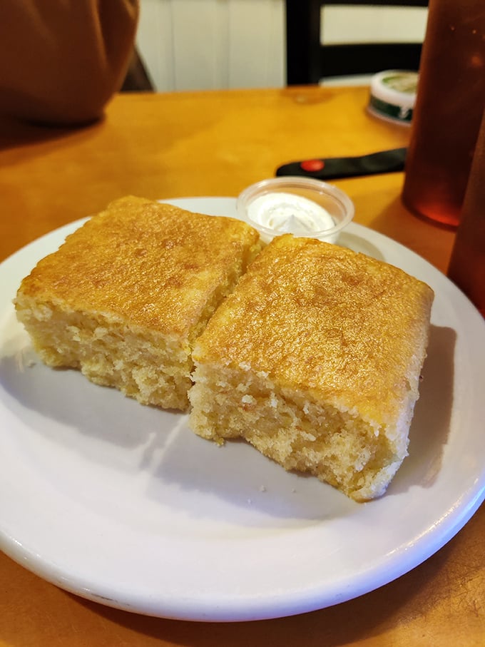 Cornbread squares that strike the perfect sweet-savory balance – moist inside, slightly crisp outside, impossible to eat just one piece.