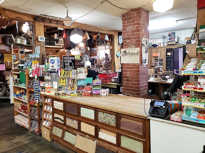 Where commerce meets history at a wooden counter worn smooth by generations of elbows and friendly conversations. This isn't just a checkout—it's a community crossroads.
