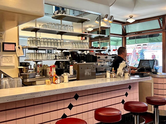 The counter—where magic happens, glasses hang like crystal stalactites, and staff choreograph the daily dance of eggs, coffee, and conversation.