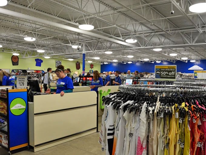 The checkout area buzzes with activity as treasures find new homes. The final step in the thrifting adventure—victory at the register!