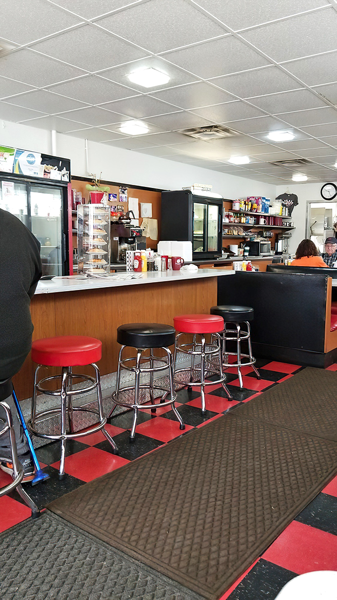 Counter seating where regulars have worn grooves into those classic red and black stools – the best spot for solo diners and coffee refill efficiency.