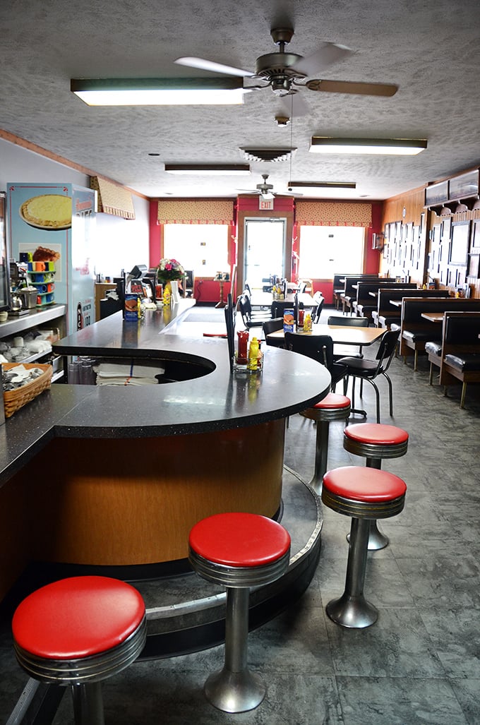 The counter where strangers become friends, complete with classic red stools that have supported generations of satisfied Hoosiers.