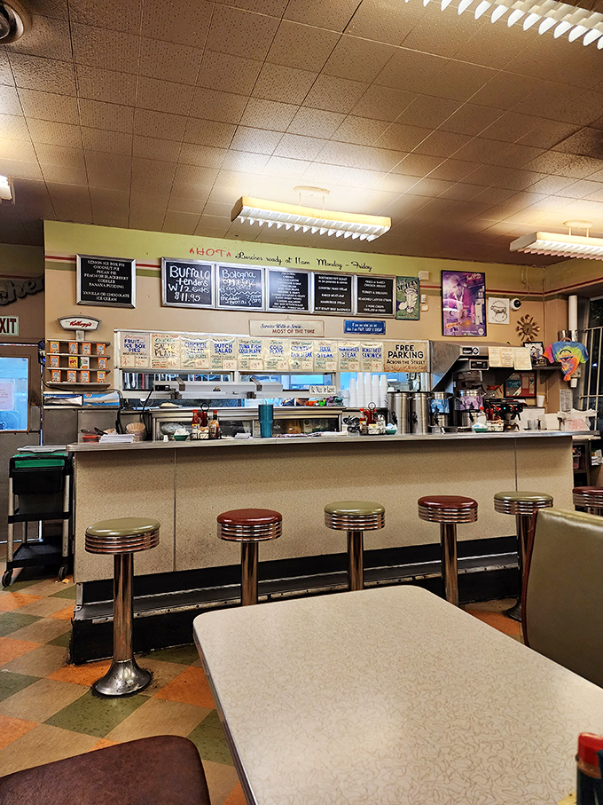 The counter seating—where solo diners become regulars and the short-order ballet unfolds before your eyes. Prime real estate for breakfast enthusiasts.