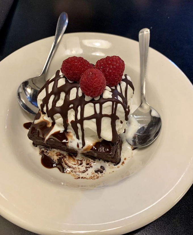 Chocolate decadence with raspberry ambassadors—the kind of dessert that makes you consider starting with the final course next time.