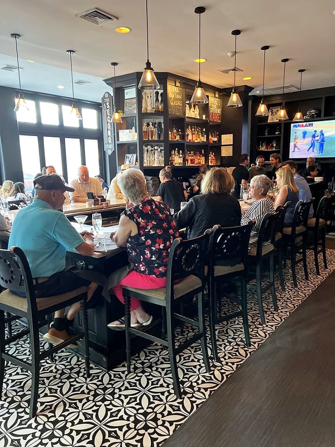 The bustling bar area where strangers become friends, united by the universal language of exceptional food and drink in an atmosphere of convivial charm.