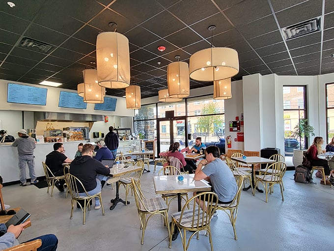 Where strangers become neighbors over coffee and cheesecake. The golden chairs aren't just seating—they're front-row tickets to Newark's daily symphony.