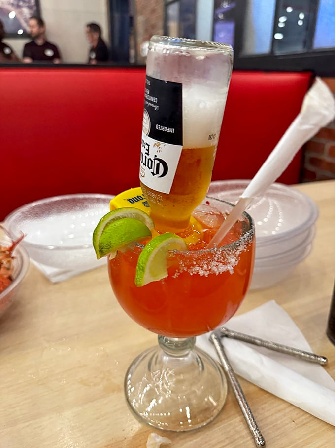 A "Coronarita"—the architectural marvel of drinks, with a Corona tipped into a margarita, proving excess isn't limited to the food offerings.