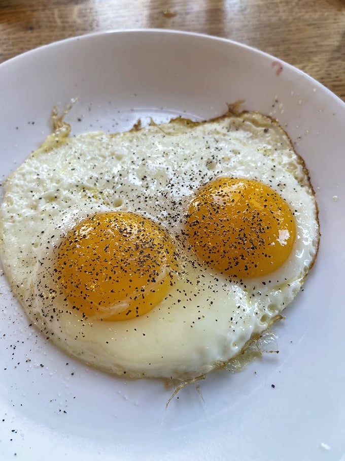 Two sunny-side up eggs staring back at you like breakfast's version of the Mona Lisa—simple perfection that needs no explanation.