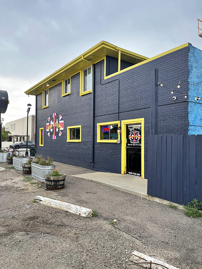 The navy blue exterior with bright yellow trim stands out like a British sailor on shore leave—impossible to miss and beckoning you inside.