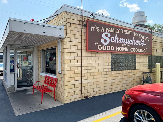 The welcoming entrance with its iconic sign and red bench – the gateway to comfort food paradise. Like stepping into your favorite relative's kitchen, if they happened to make world-class pie.