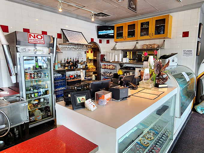 The front counter—where dreams of pastrami are fulfilled and the display case tempts you with desserts you swore you were too full to consider.