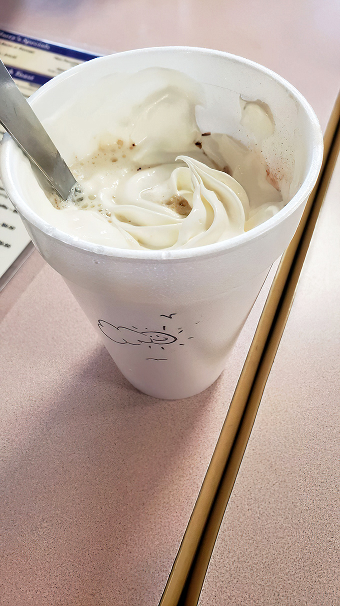 A mountain of whipped cream atop hot chocolate—because sometimes breakfast should feel like you're getting away with something.