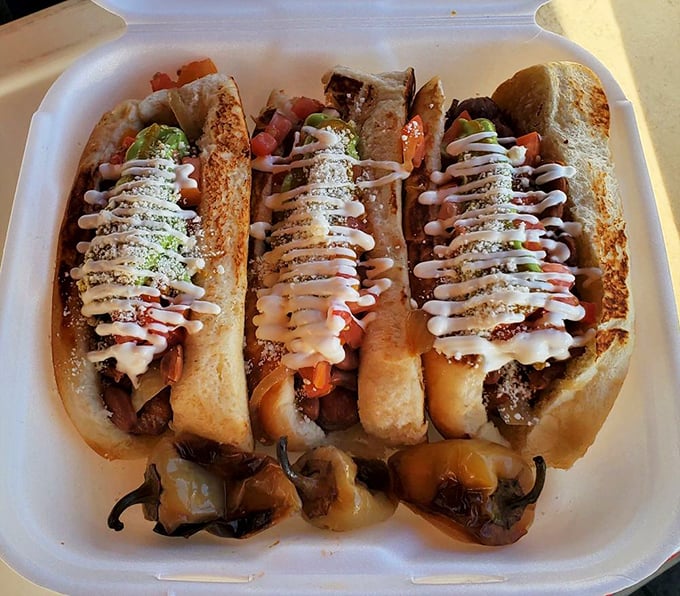 The holy trinity of Sonoran hot dogs. Those grilled peppers on the side aren't garnish – they're the backup singers that complete the band.