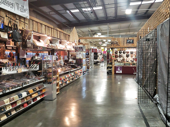 This immaculately organized aisle showcases the more upscale side of flea market finds—leather goods and collectibles displayed with boutique-worthy precision.