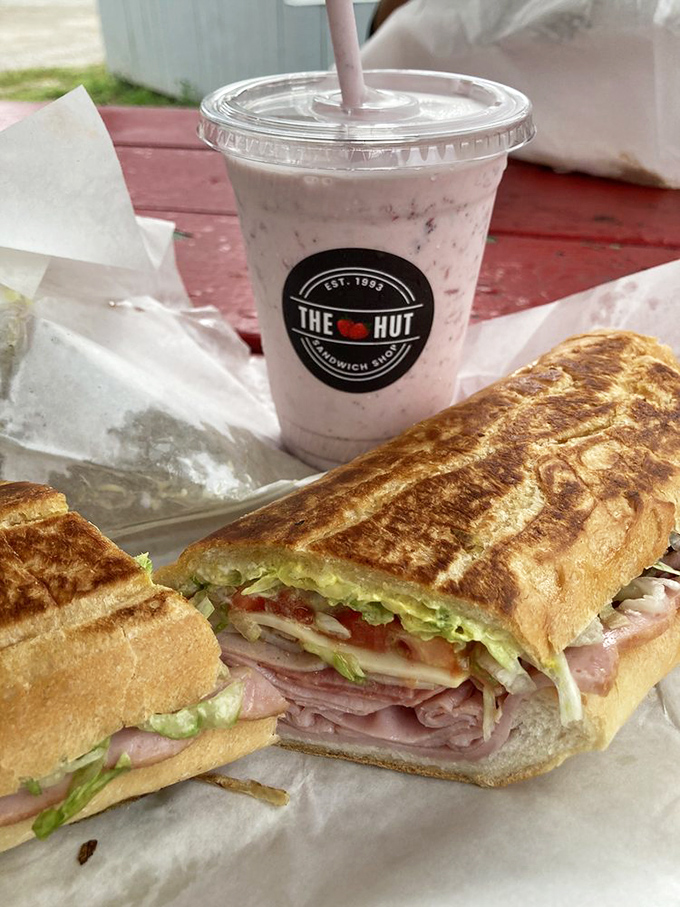 The ultimate power couple: a perfectly pressed Cuban sandwich alongside a creamy strawberry shake. Name a more iconic duo—I'll wait.