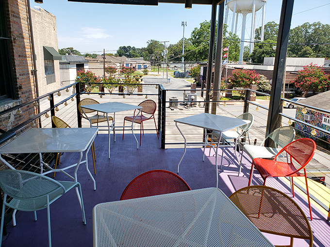 The outdoor seating area offers a slice of small-town Arkansas life with colorful chairs that invite you to linger over coffee or cocktails.