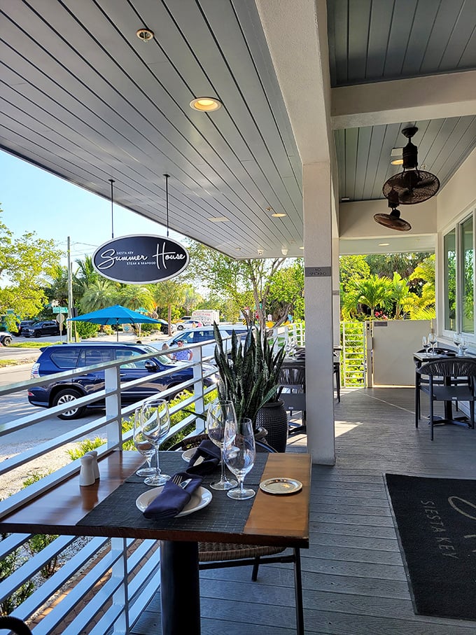 Outdoor seating that captures Florida's essence—palm-framed views, gentle breezes, and tables set for memorable meals under blue skies.