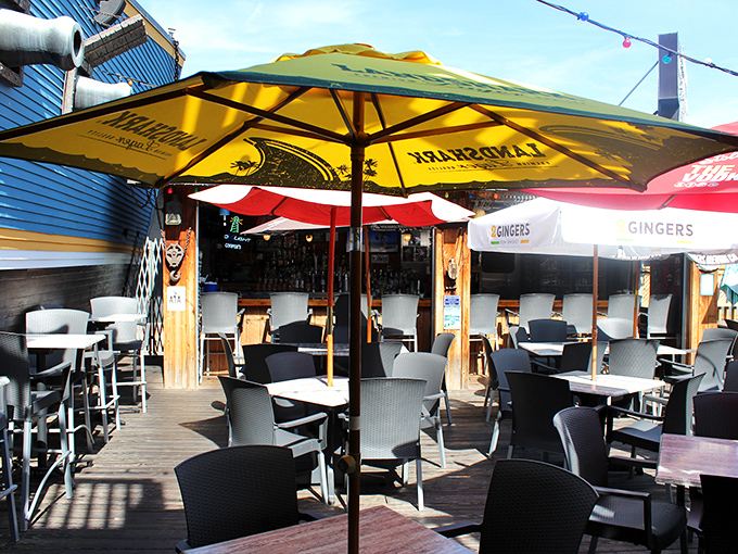The outdoor deck offers a sunny escape with colorful umbrellas, where summer cocktails and people-watching become an official sport.