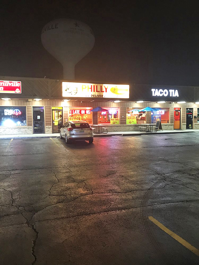 As night falls, the illuminated sign serves as a beacon for the hungry, promising satisfaction well into the evening hours.