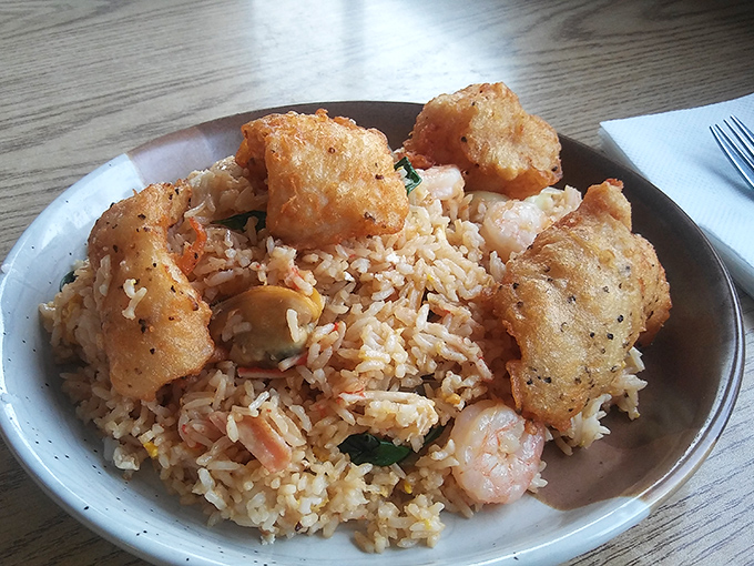Fried rice that refuses to be a mere side dish. Studded with seafood and topped with crispy morsels, it demands—and deserves—center stage.